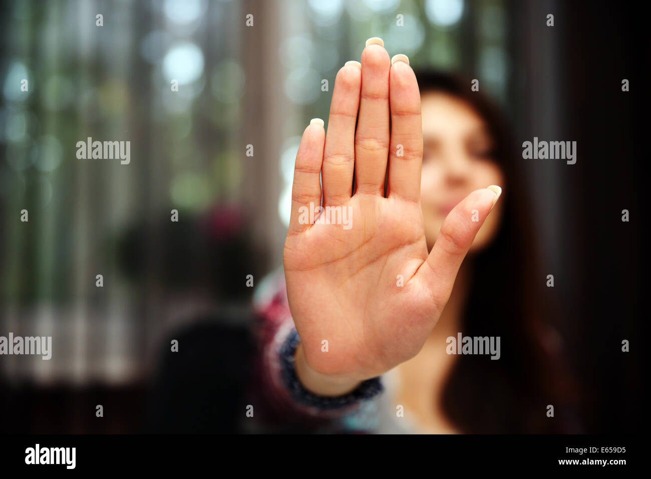 Woman with her hand extended signaling to stop (only her hand is in ...