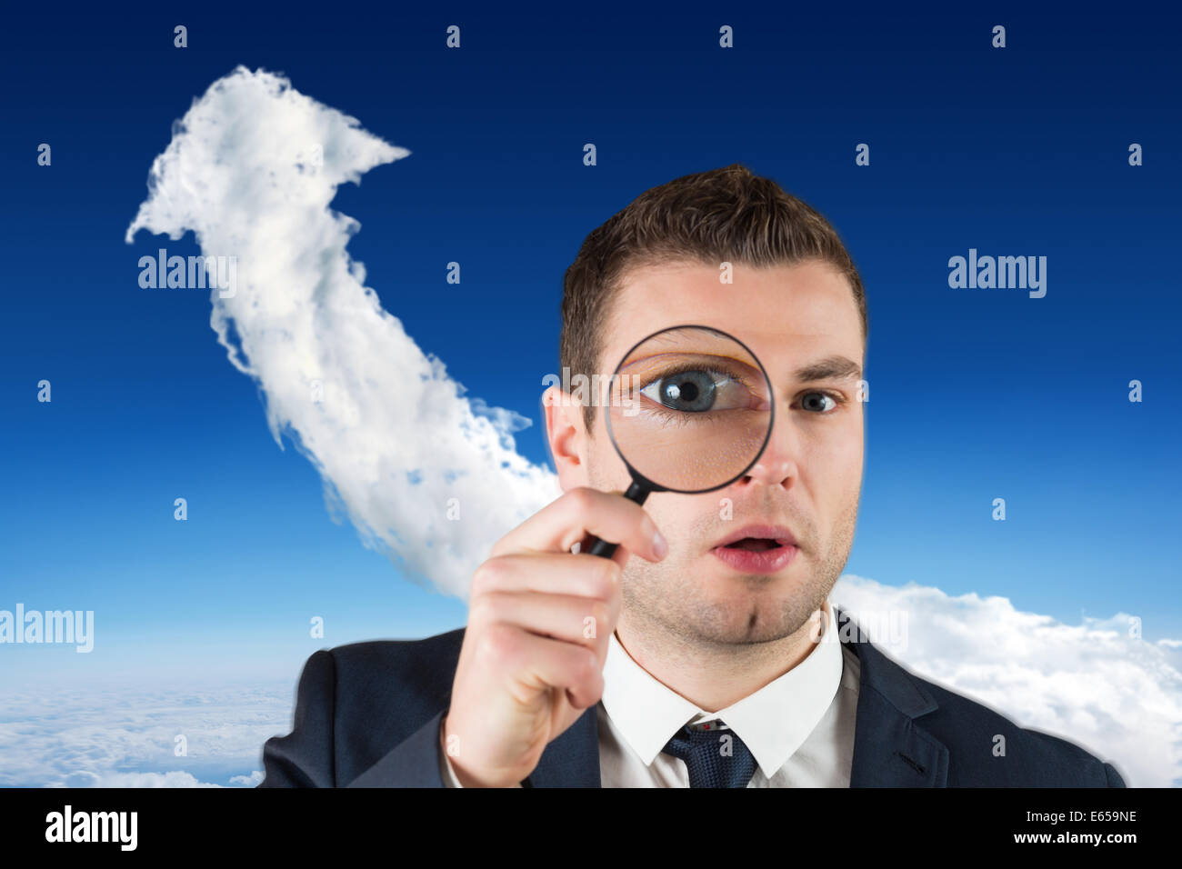 Composite image of businessman looking through magnifying glass Stock ...