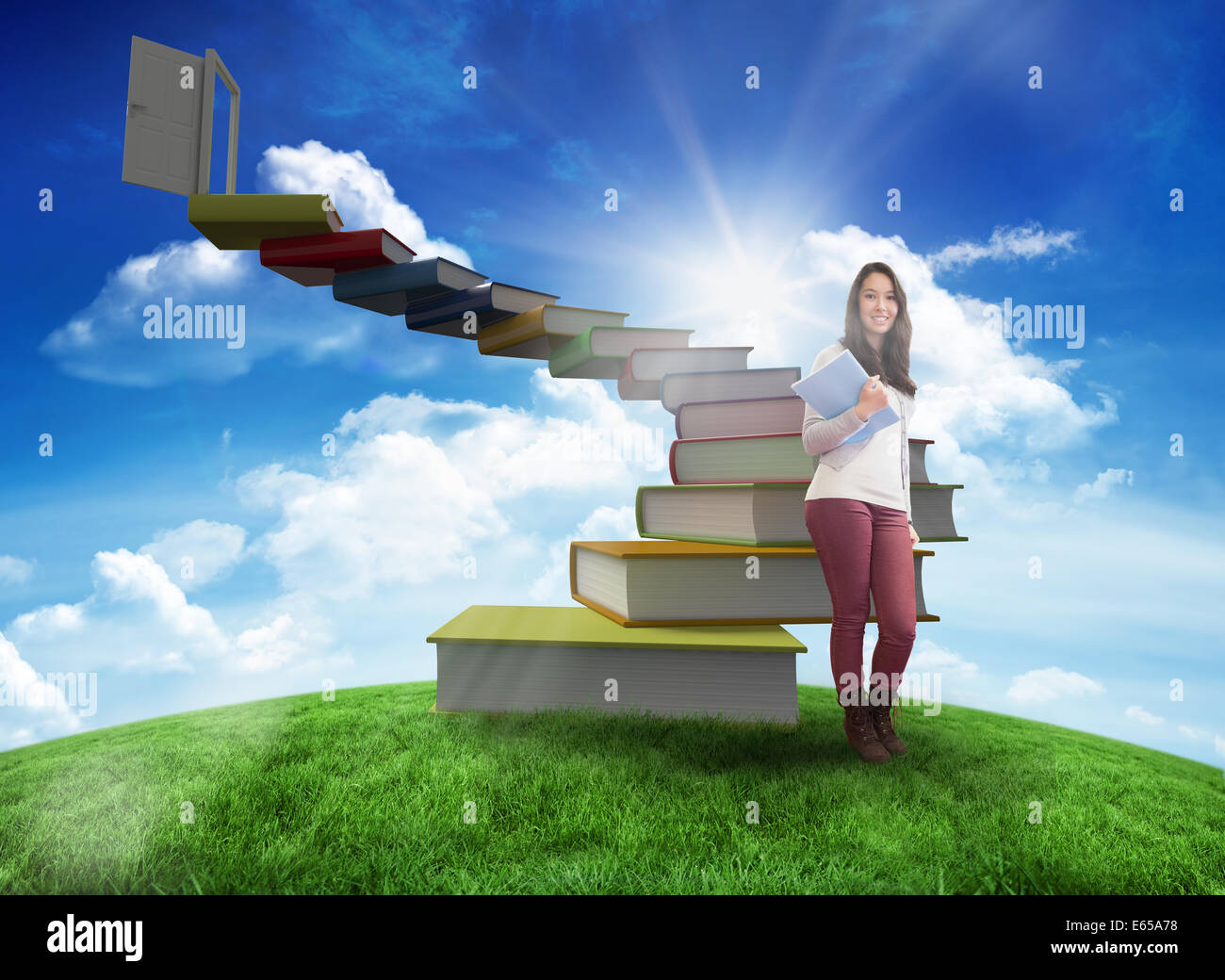 Composite image of smiling student holding textbook Stock Photo - Alamy