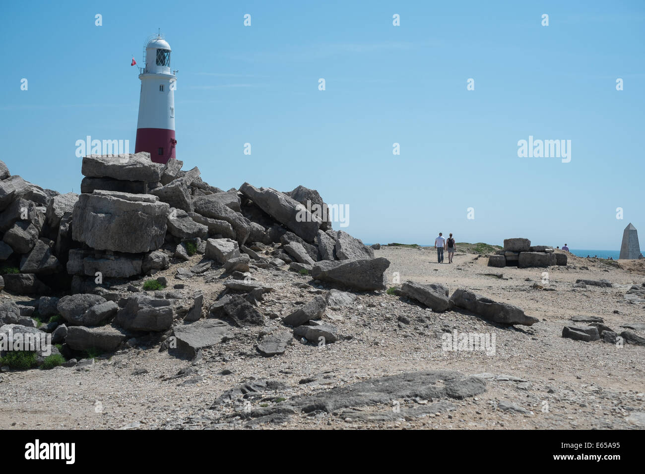 Lighthouse and rocks Stock Photo - Alamy