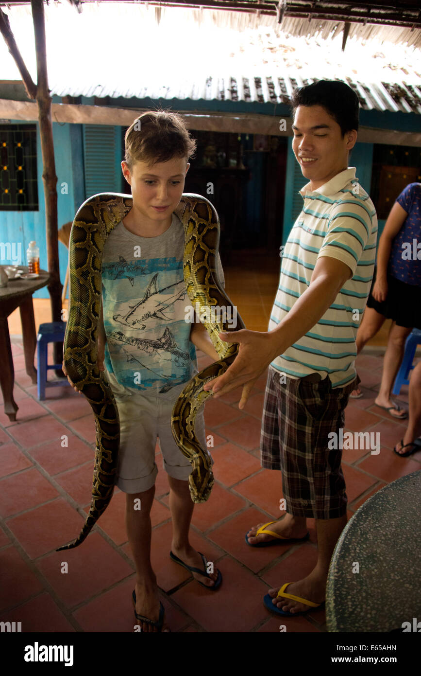 Western boy with snake, Vietnam Stock Photo - Alamy