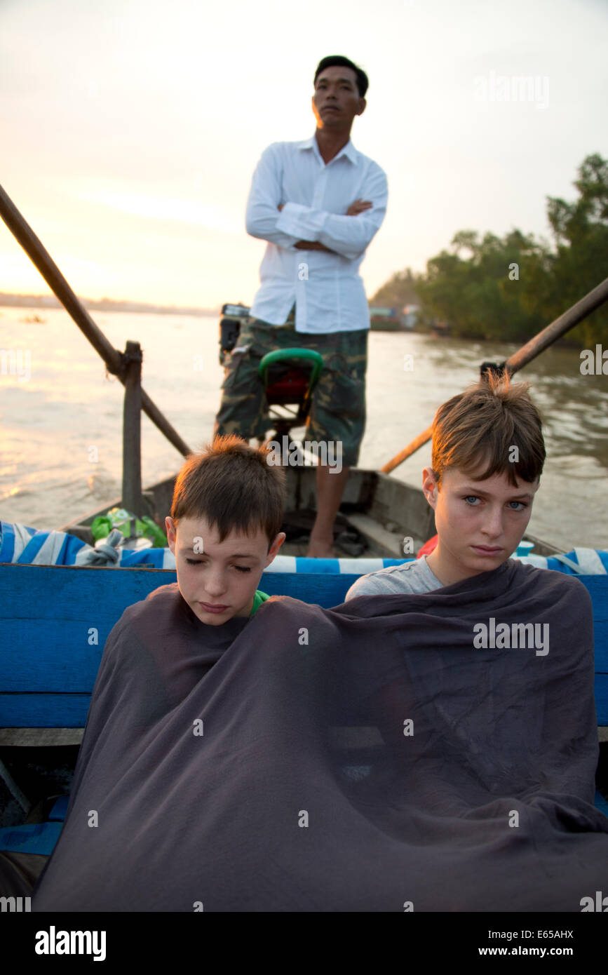 Western boys in boat, Vietnam Stock Photo - Alamy