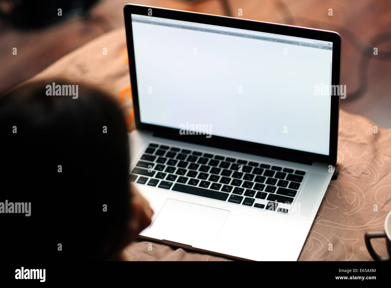 Back view portrait of a woman looking at laptop Stock Photo - Alamy