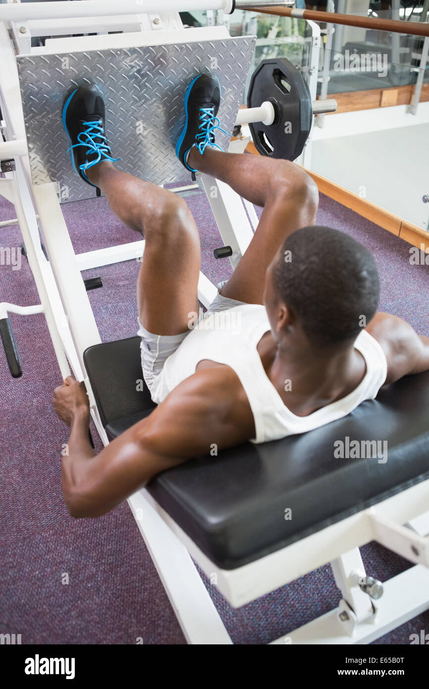 Male weightlifter doing leg presses in gym Stock Photo - Alamy