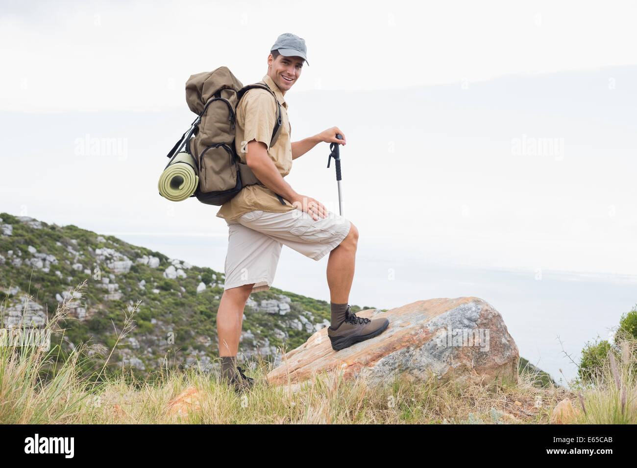 Hiking man walking on mountain terrain Stock Photo - Alamy