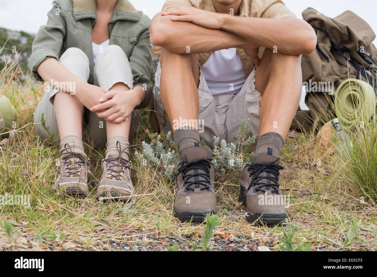 Couple taking break after hiking uphill Stock Photo - Alamy