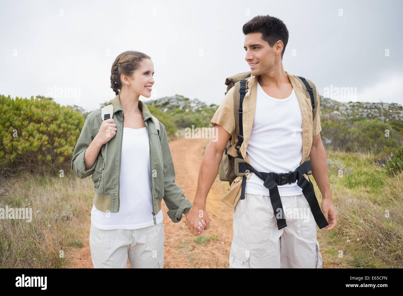 Hiking couple walking on mountain terrain Stock Photo - Alamy