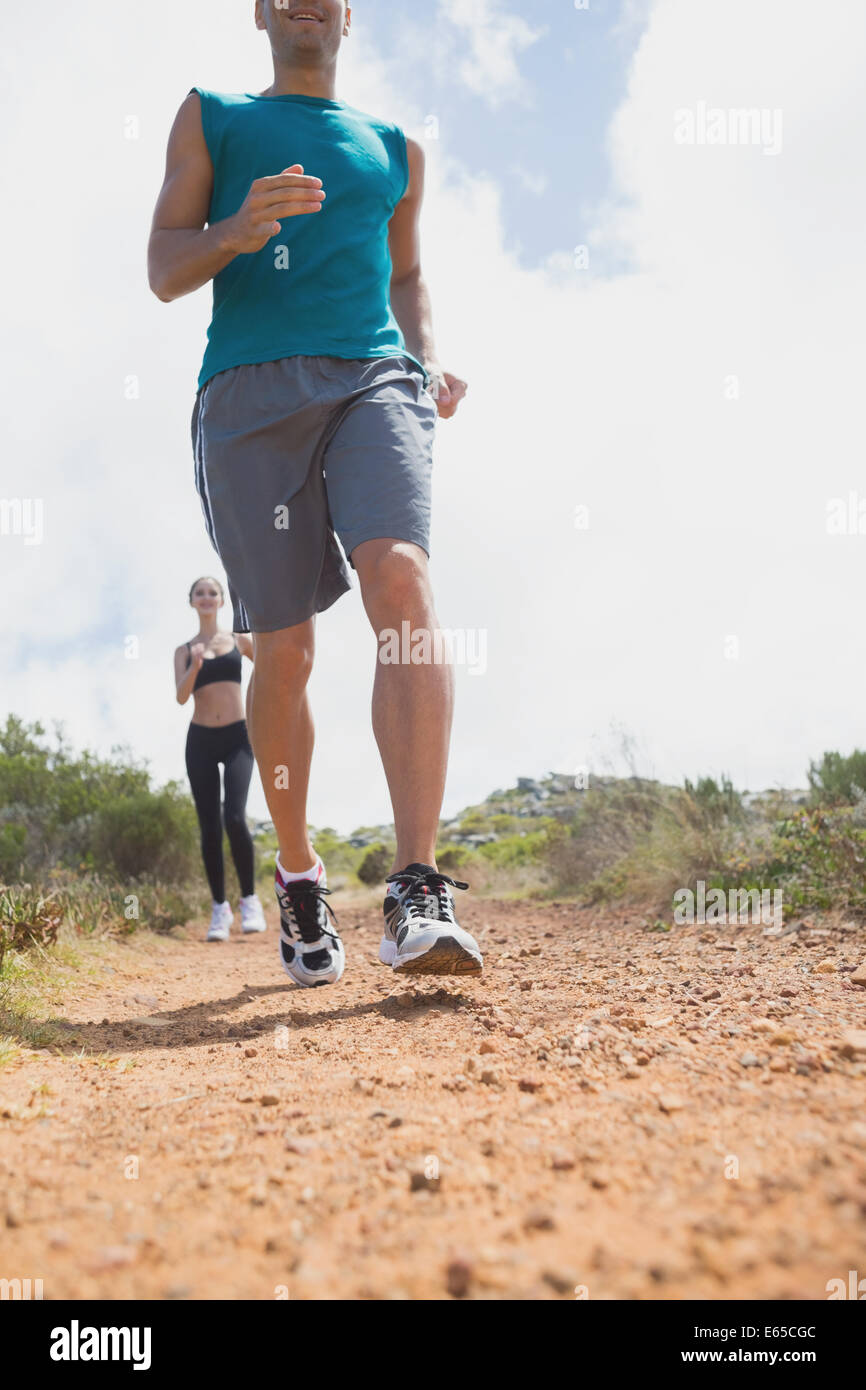 Couple running on countryside road Stock Photo - Alamy