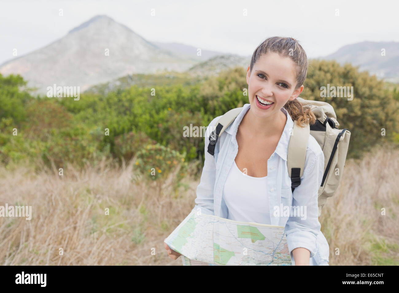 Portrait of a hiking young woman holding map Stock Photo - Alamy