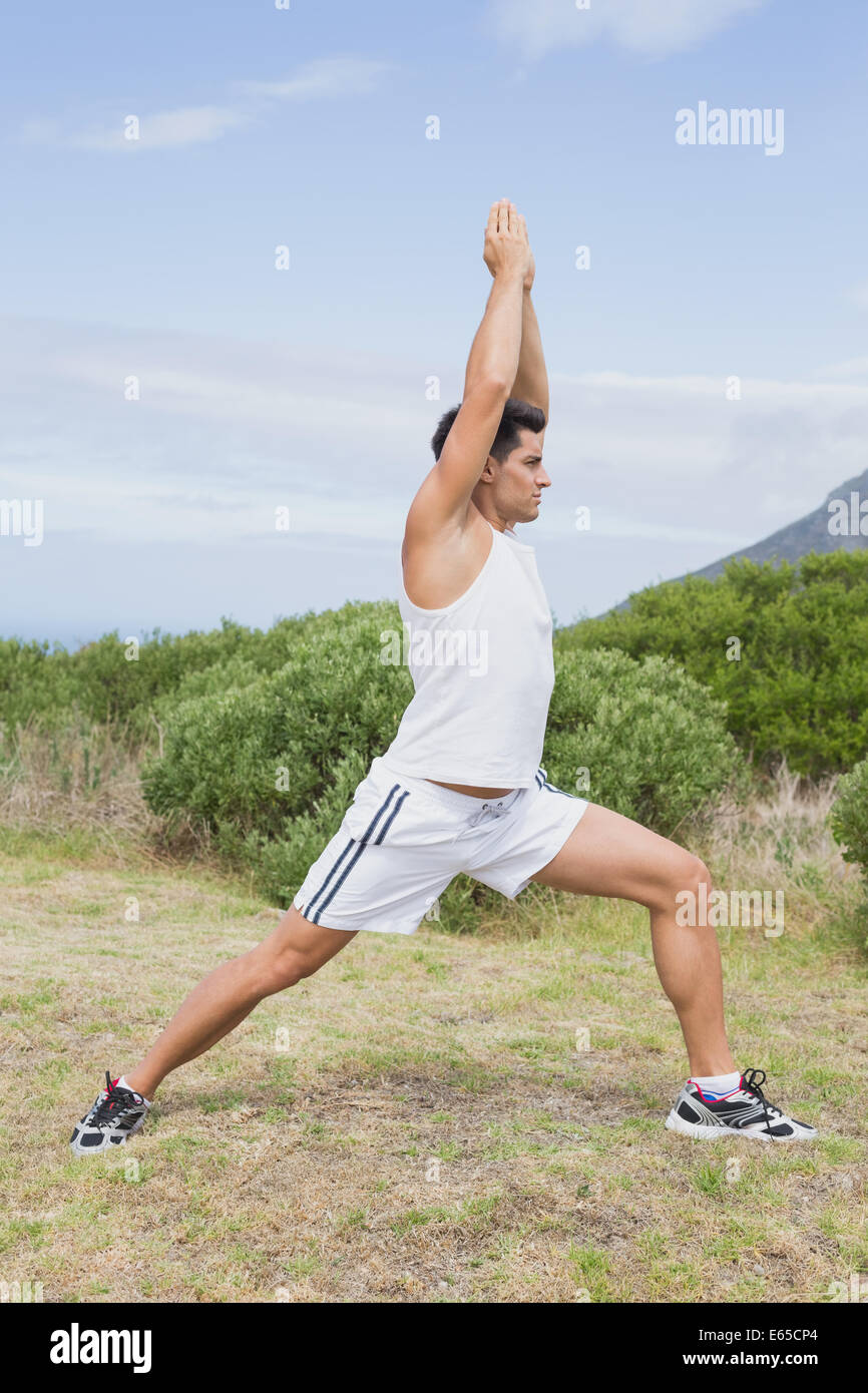 Man doing stretching exercises on countryside landscape Stock Photo - Alamy