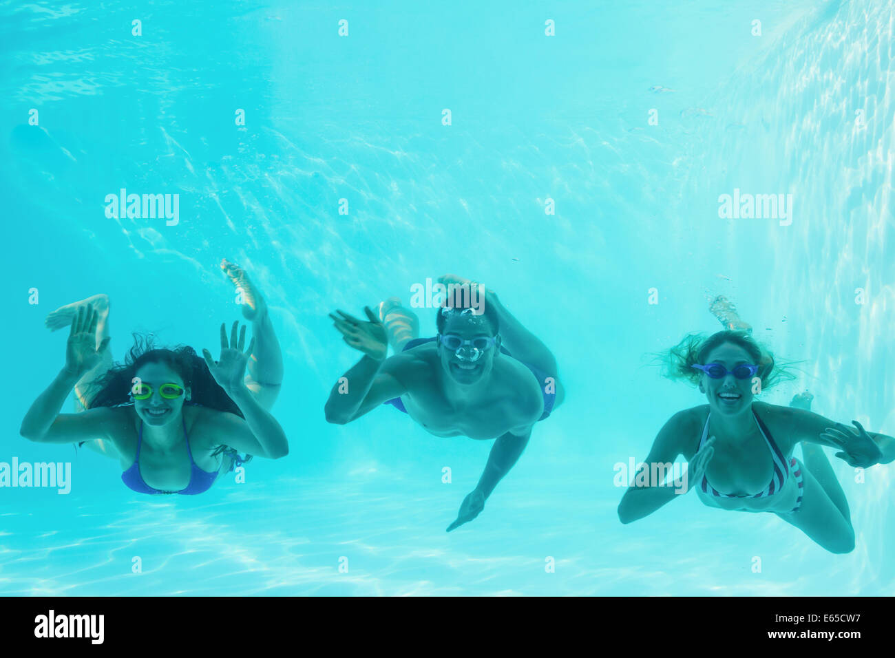 Friends underwater in swimming pool Stock Photo - Alamy