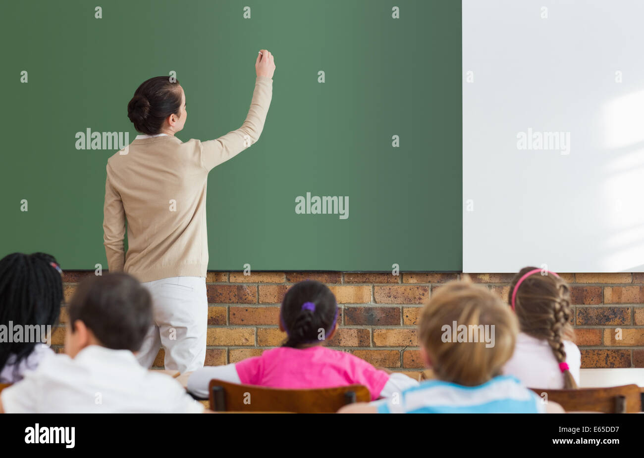 Pupils listening to their teacher at chalkboard Stock Photo - Alamy