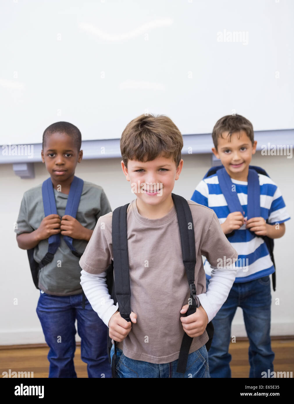 Classmates smiling together in classroom Stock Photo - Alamy