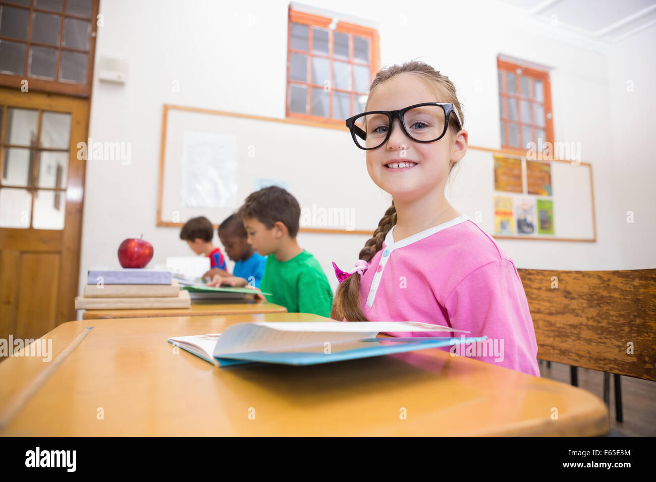 Cute pupils reading at desks Stock Photo - Alamy