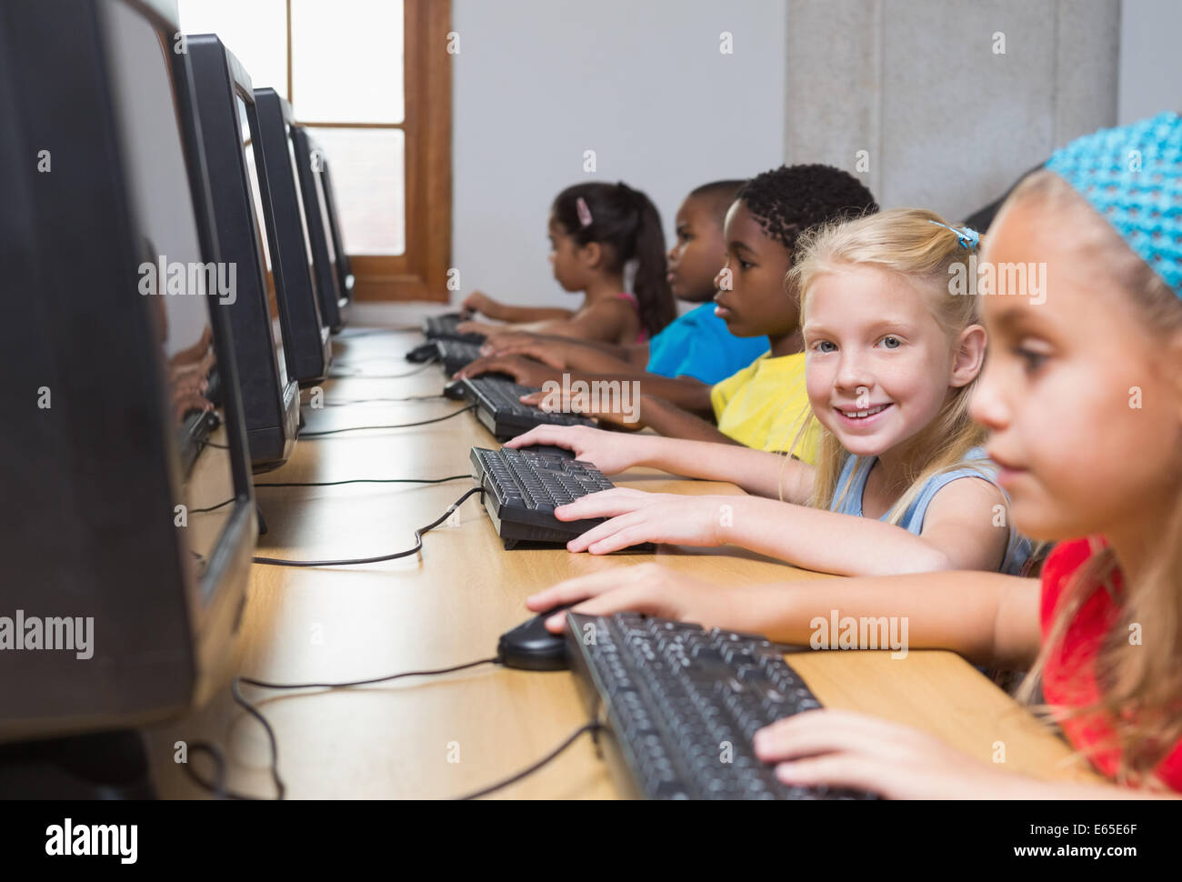 Cute pupils in computer class Stock Photo - Alamy
