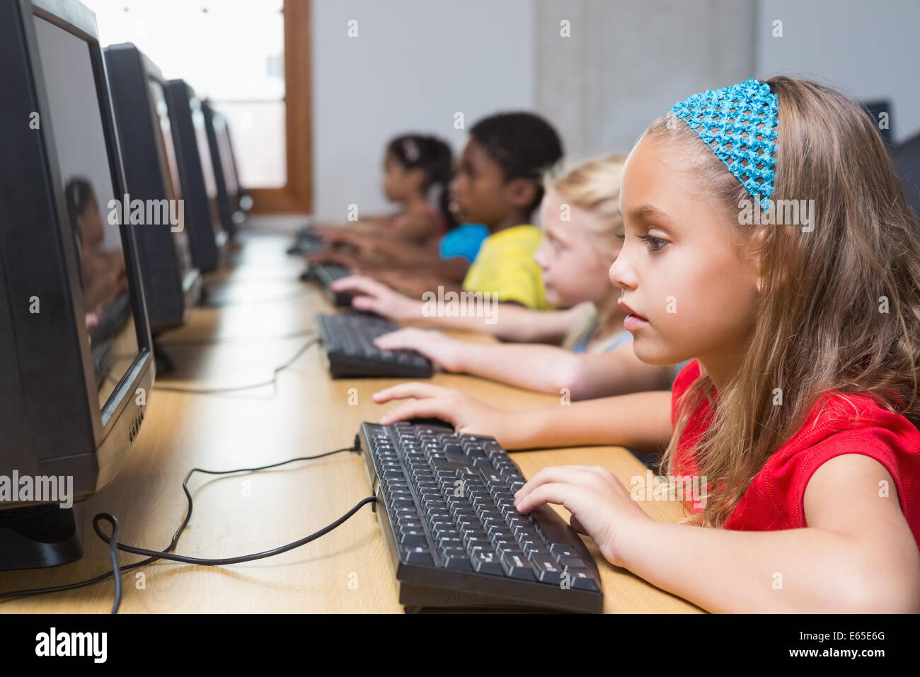 Cute pupils in computer class Stock Photo - Alamy