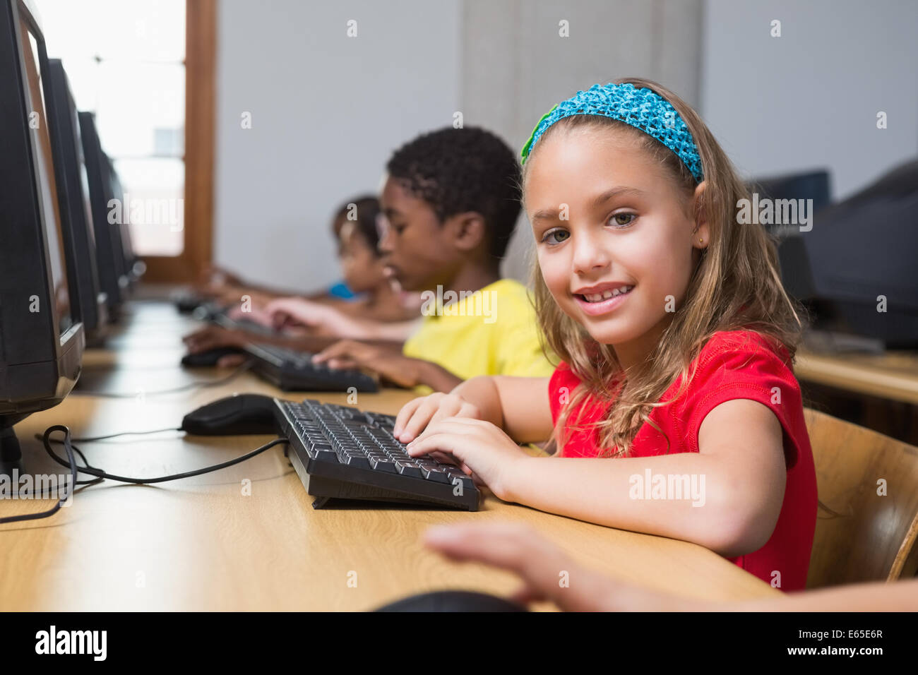 Cute pupils in computer class Stock Photo - Alamy