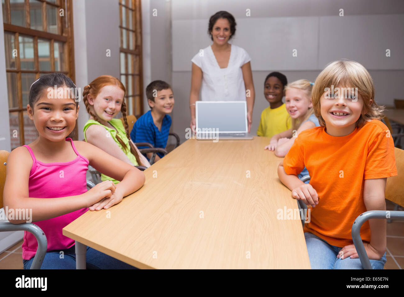 Happy pupils using laptop class hi-res stock photography and images - Alamy