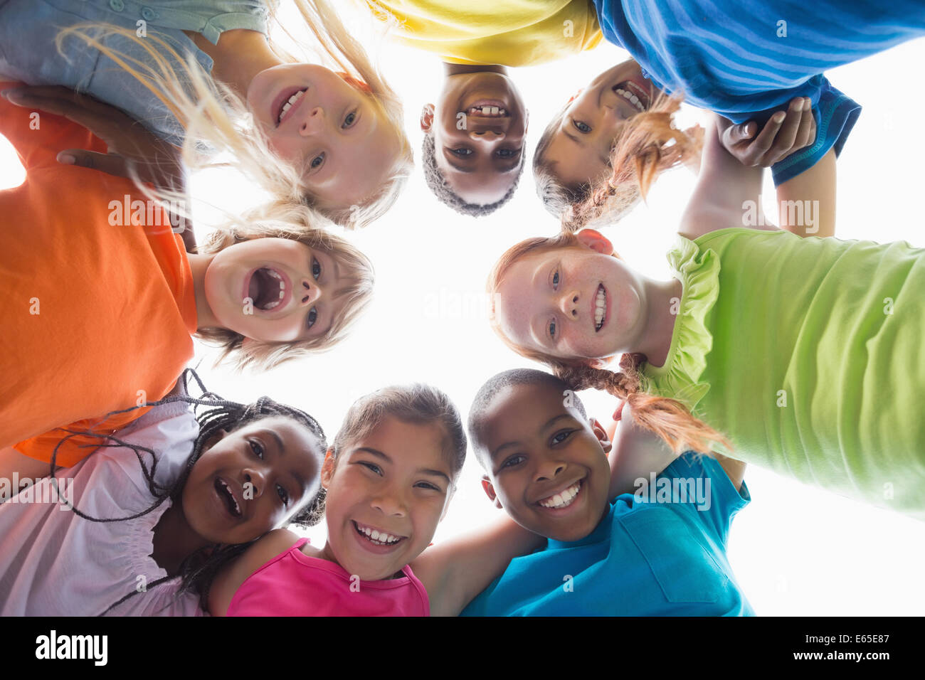 Cute pupils smiling down at camera outside Stock Photo - Alamy