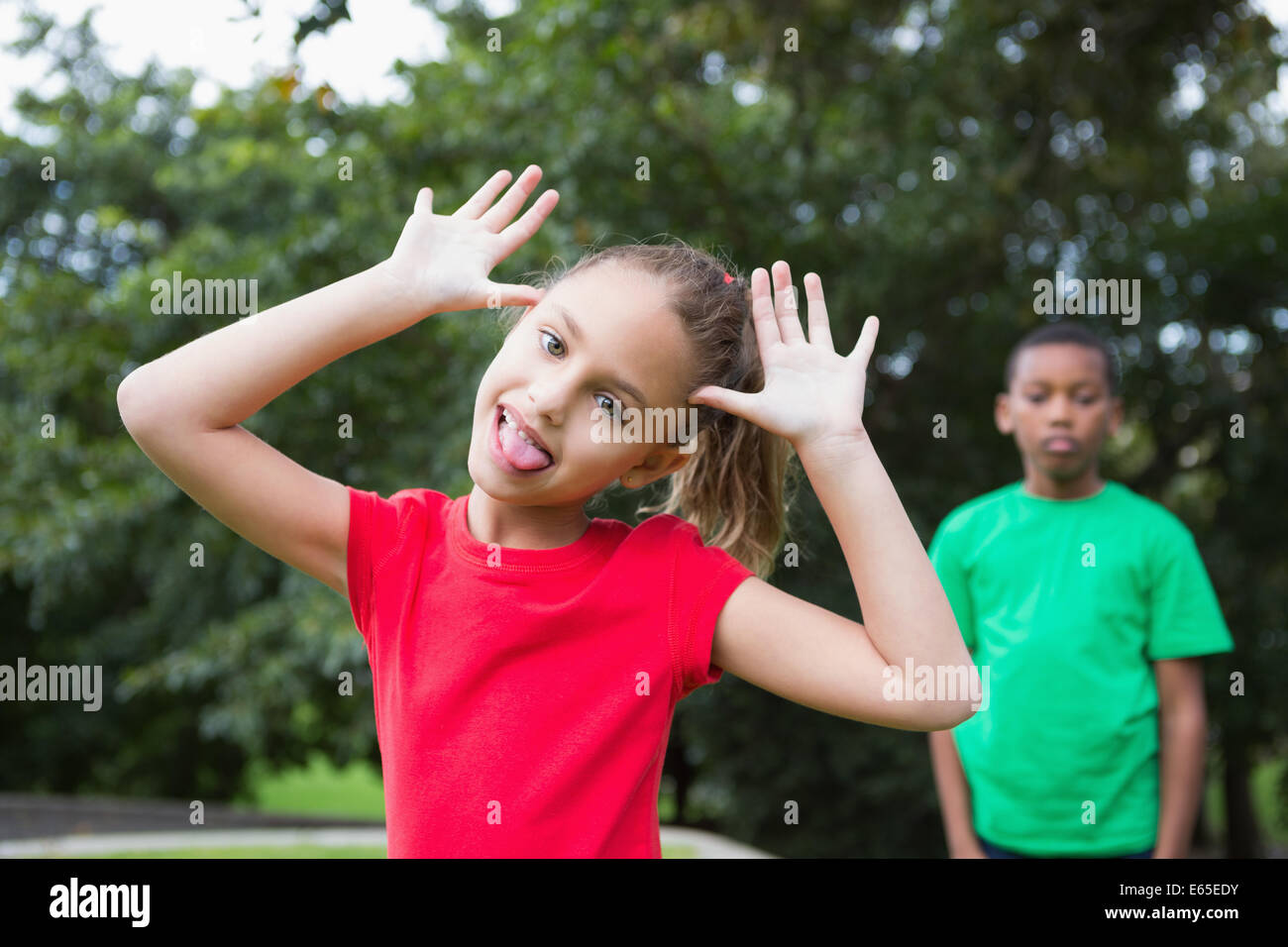 Cute little boy making silly faces outside Stock Photo - Alamy