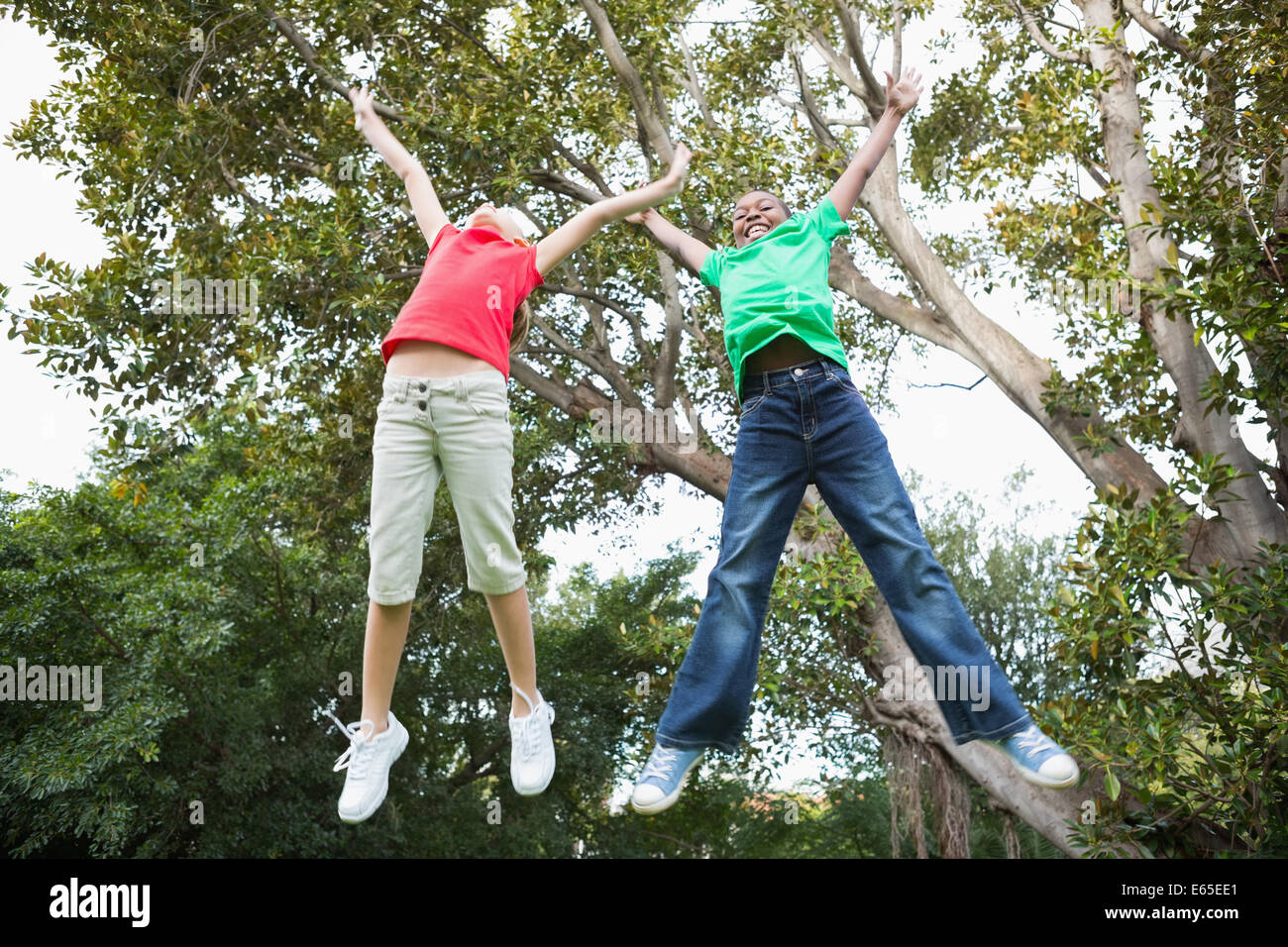 Cute children jumping up outside Stock Photo - Alamy