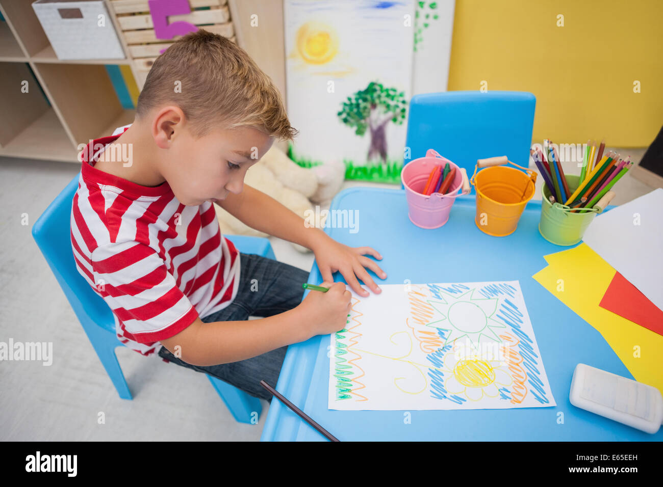 Cute little boy drawing at desk Stock Photo - Alamy