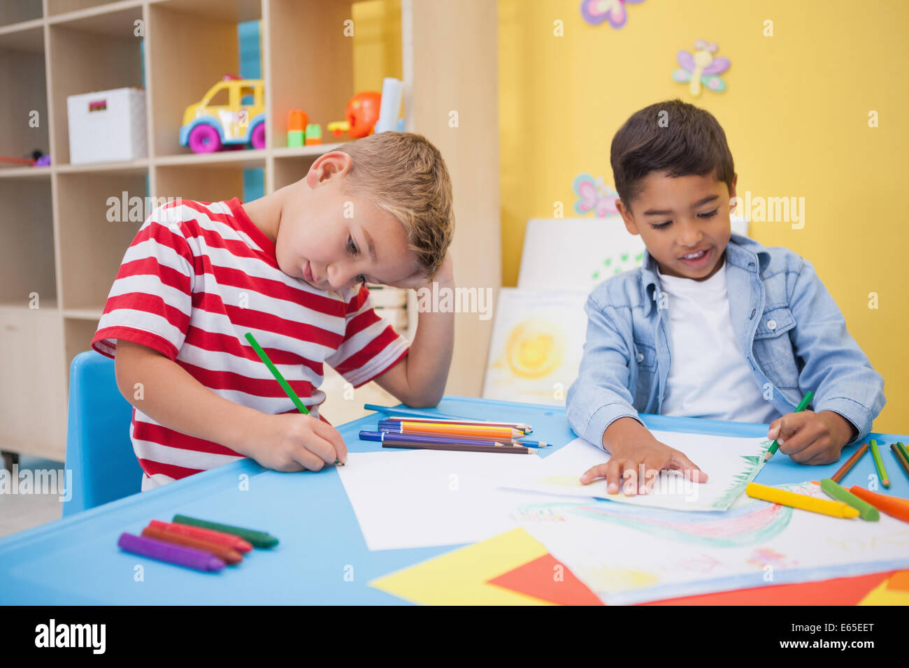 Cute little boys drawing at desk Stock Photo - Alamy