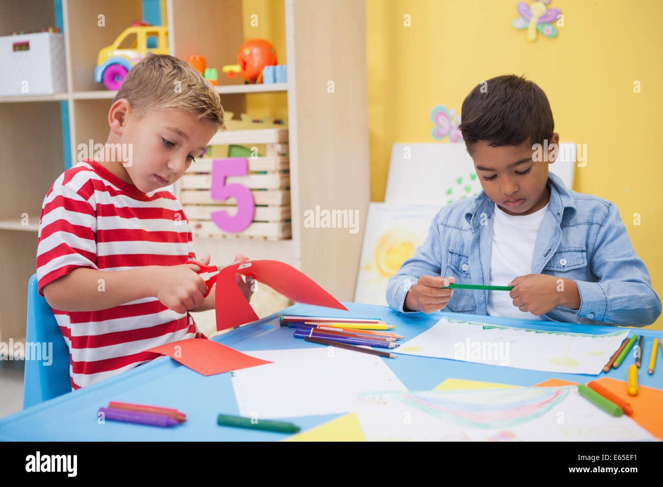 Cute little boys drawing at desk Stock Photo - Alamy
