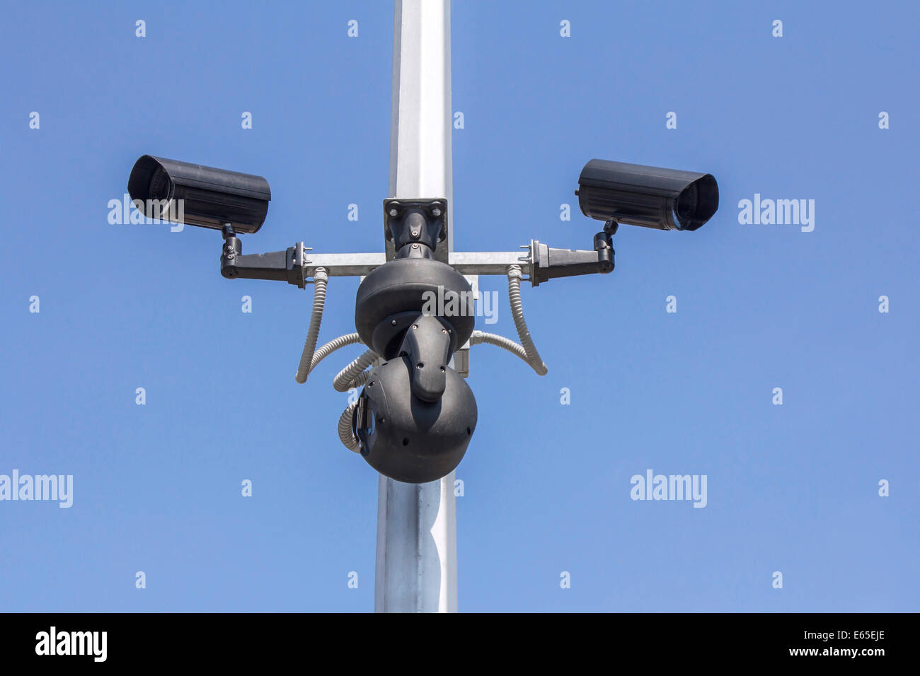 Three Security cameras on blue sky background Stock Photo - Alamy