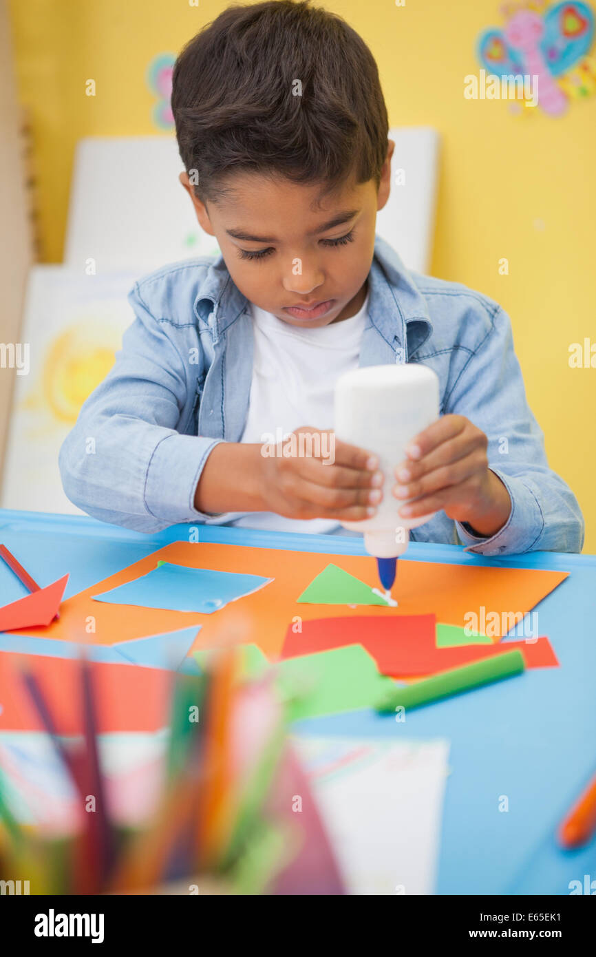 Cute little boy making art in classroom Stock Photo - Alamy