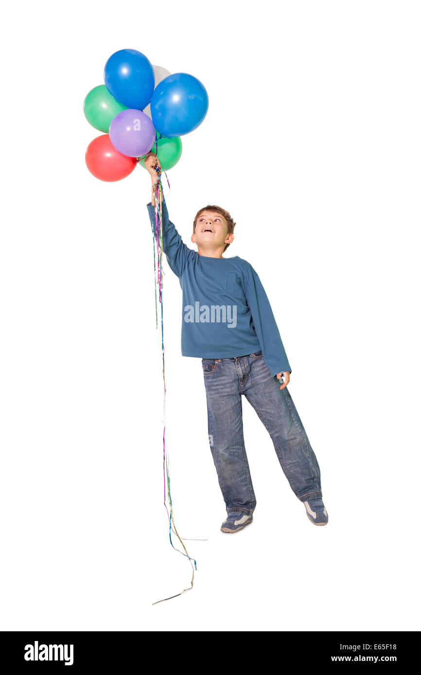 Happy little boy holding bunch of balloons Stock Photo - Alamy