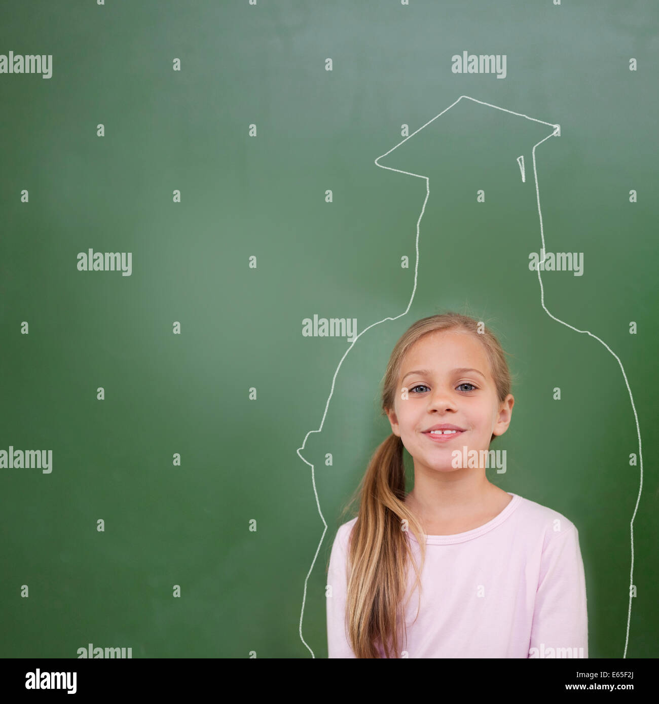 Composite image of cute pupil with graduate outline Stock Photo - Alamy