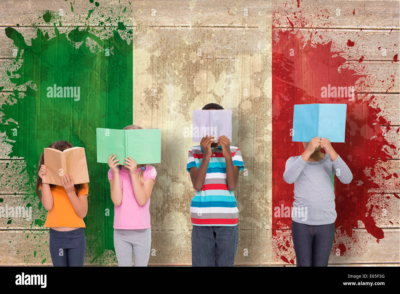 Composite image of elementary pupils reading Stock Photo - Alamy