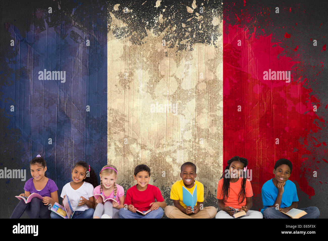 Composite image of elementary pupils reading books Stock Photo - Alamy