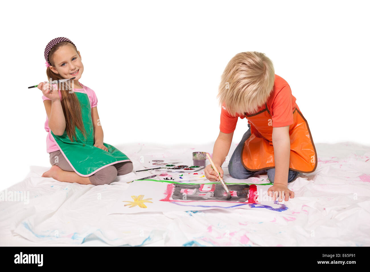 Happy little children painting on the floor Stock Photo - Alamy