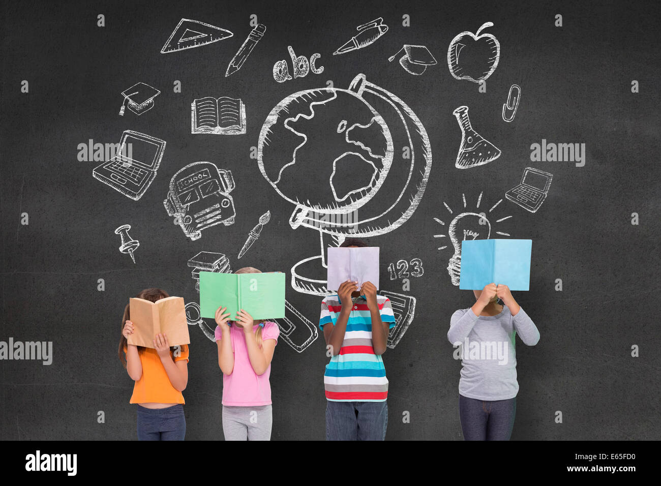 Composite image of elementary pupils reading Stock Photo - Alamy