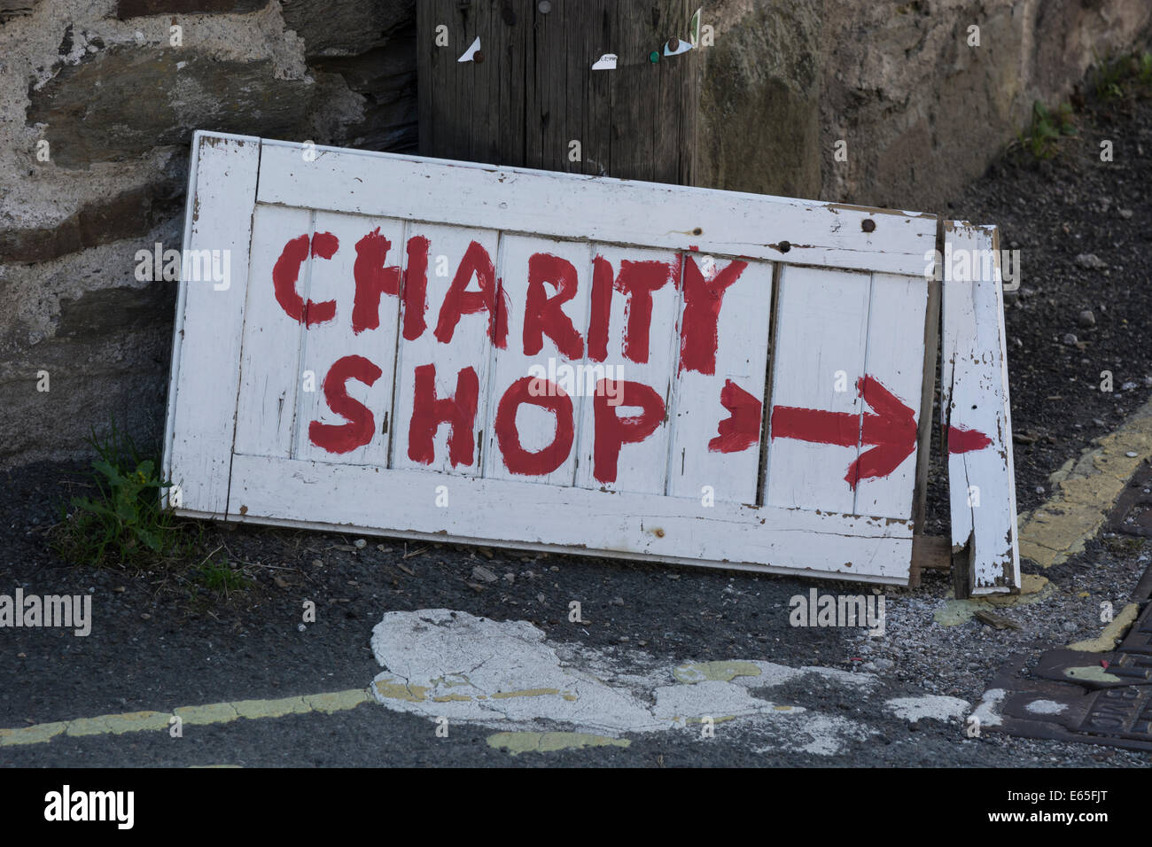 Directional sign towards a charity shop Stock Photo - Alamy