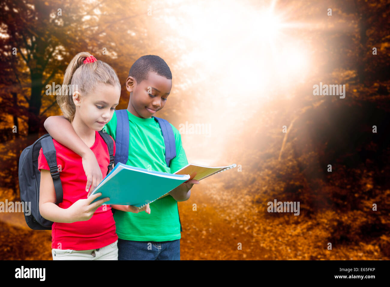 Composite image of cute pupils reading Stock Photo - Alamy