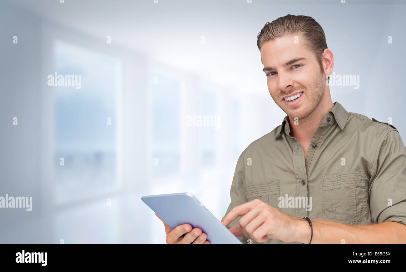 Composite image of happy man using tablet pc Stock Photo - Alamy