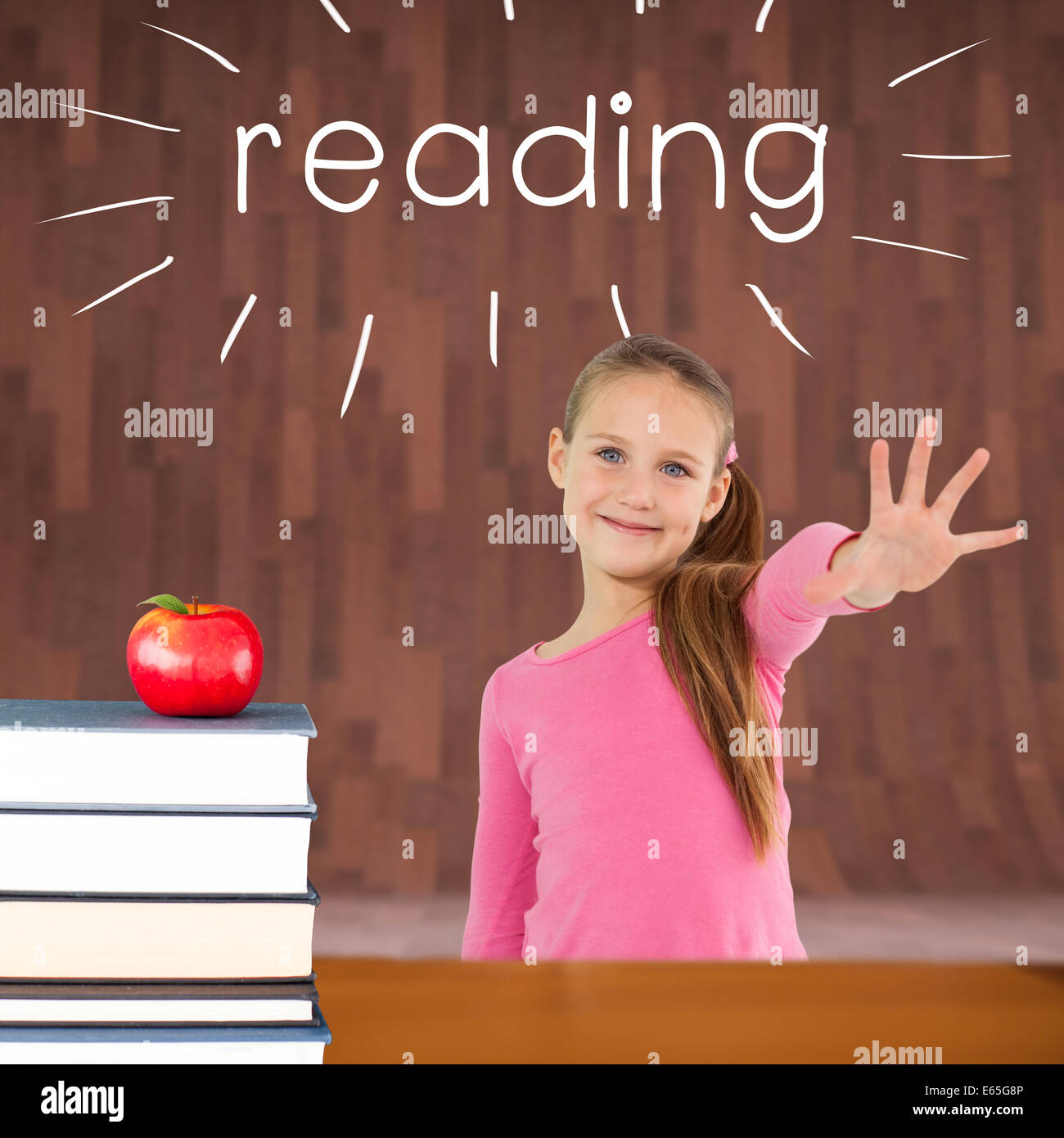 Reading against red apple on pile of books Stock Photo - Alamy