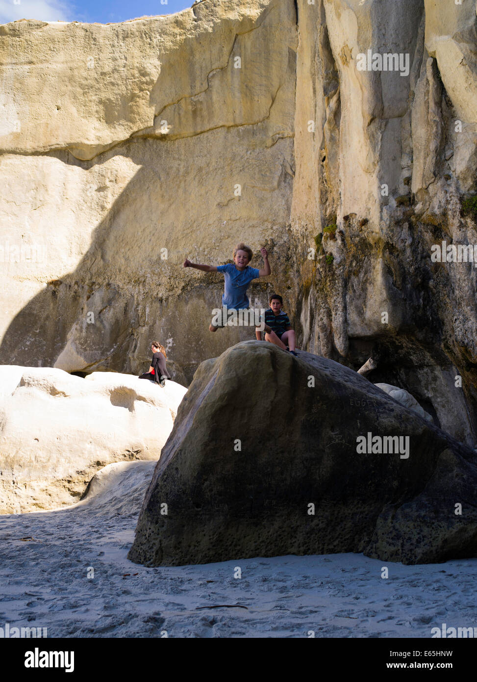 Boy jumping off rocks hi-res stock photography and images - Alamy