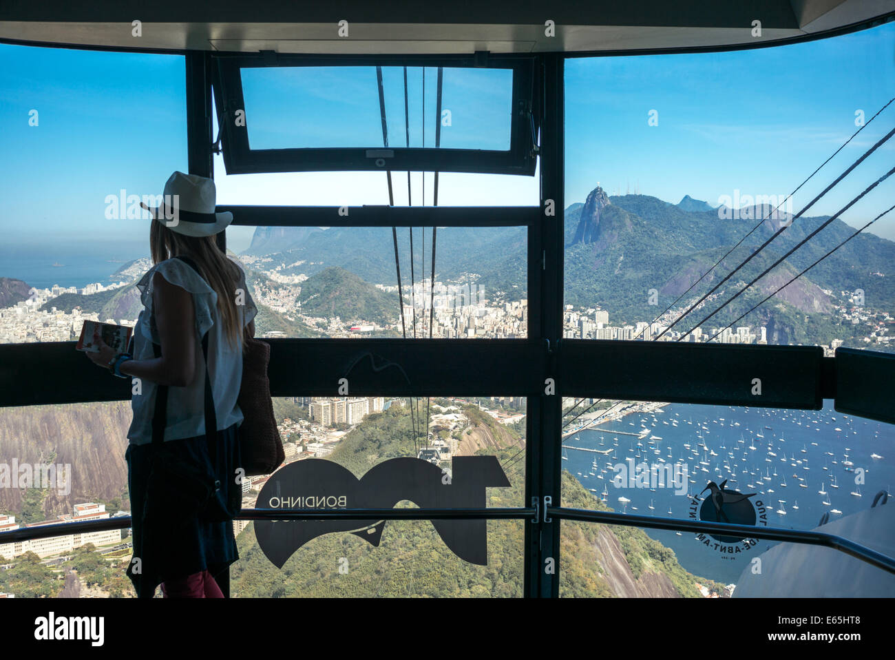 Brazil, Rio De Janeiro, a tourist on the cable car of the Pao De Acucar ...
