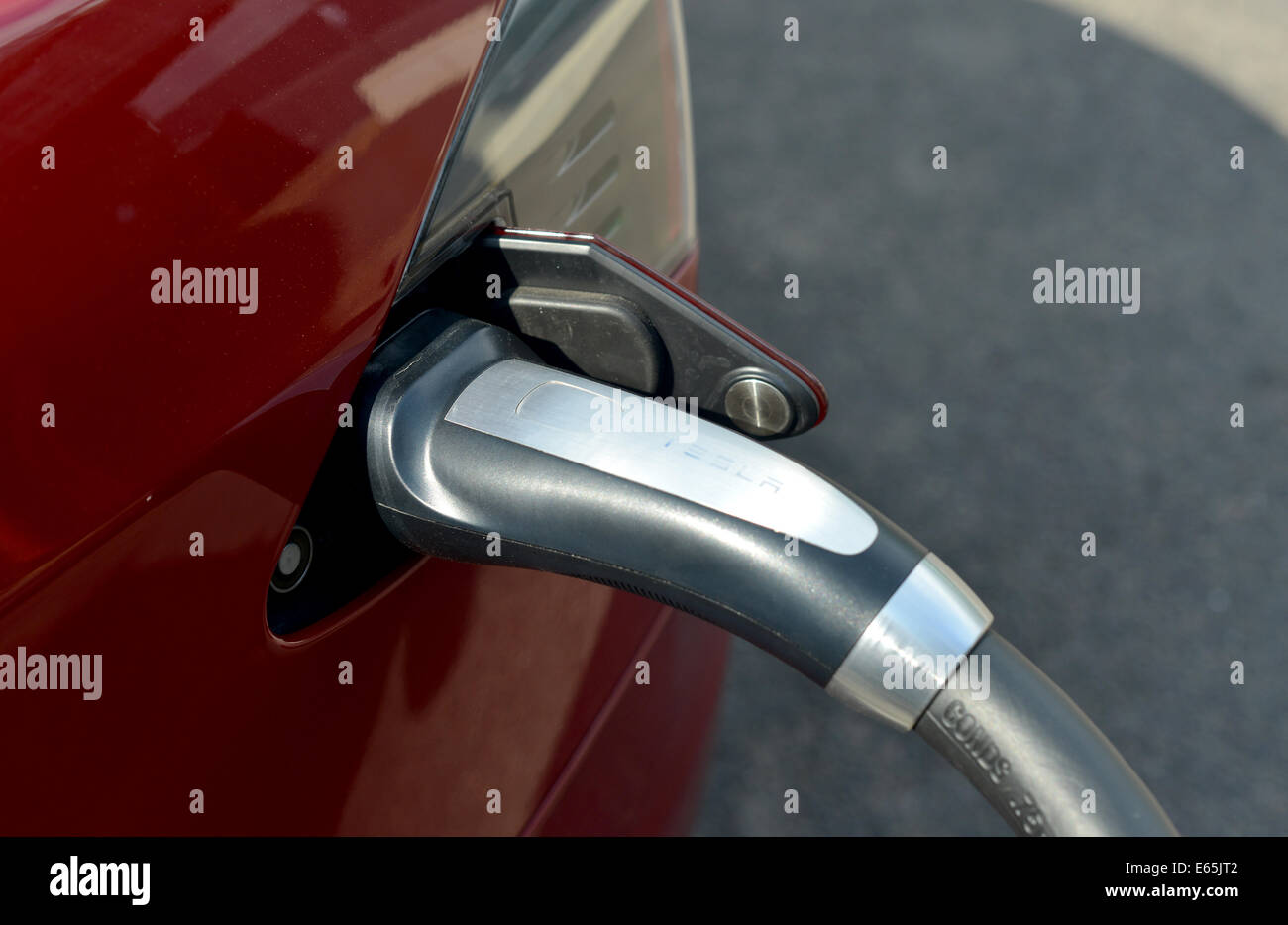 Tesla Model S electric super car charging at a Supercharger station ...