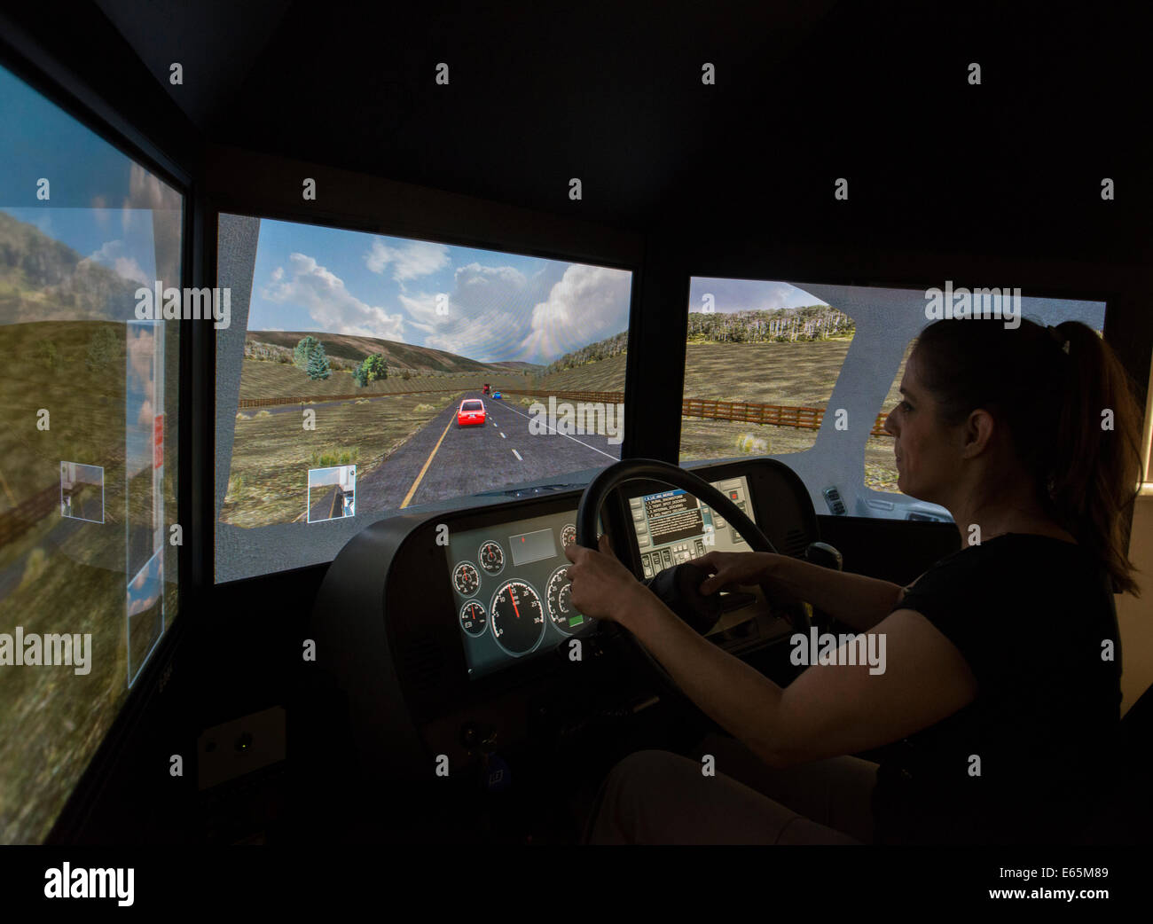 Woman uses a L-3 Communications motion based truck driving simulator ...