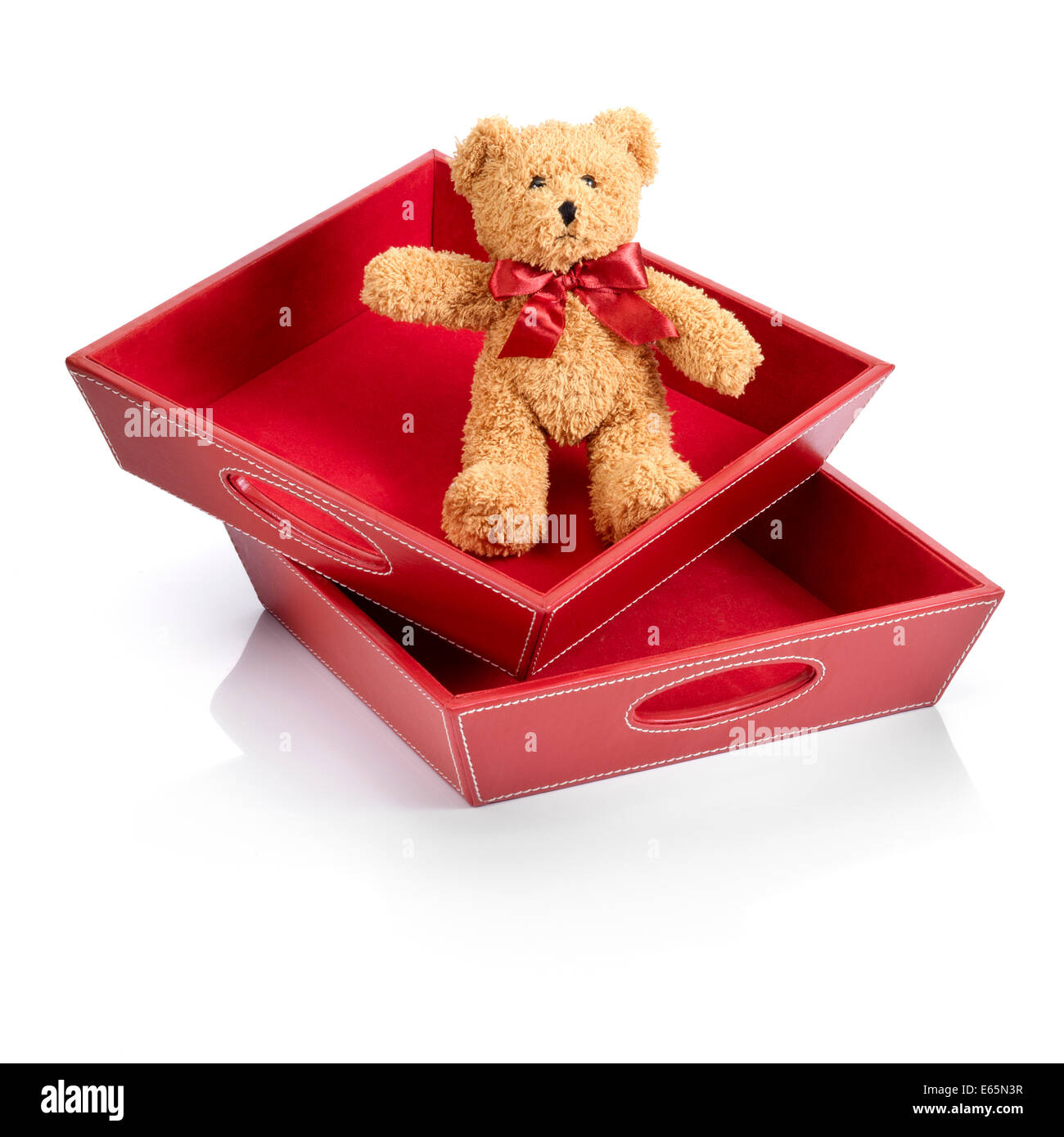 Teddy bear with a red bow into toy boxes Stock Photo - Alamy