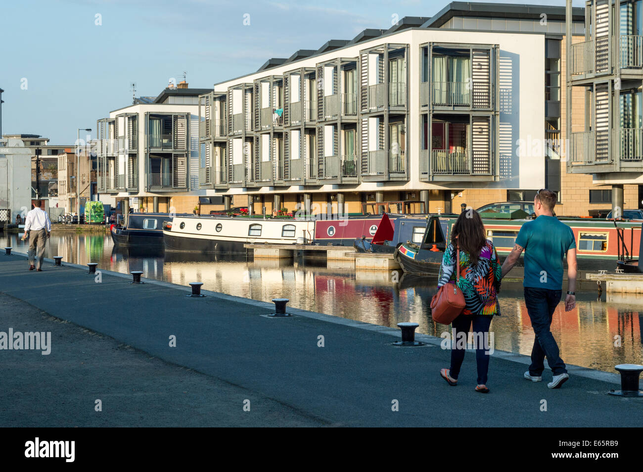 Man and woman walking along the Union canal side at Edinburgh Quay ...