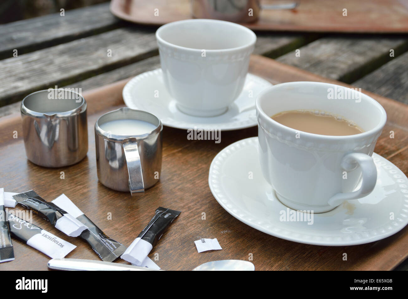 Cups of tea on a tray with small metal milk jug beside them Stock Photo ...