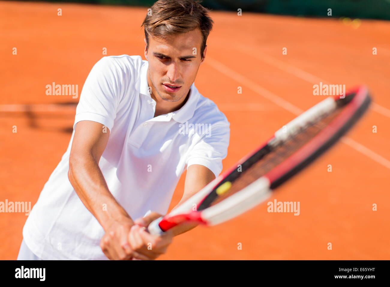 Young man playing tennis Stock Photo - Alamy