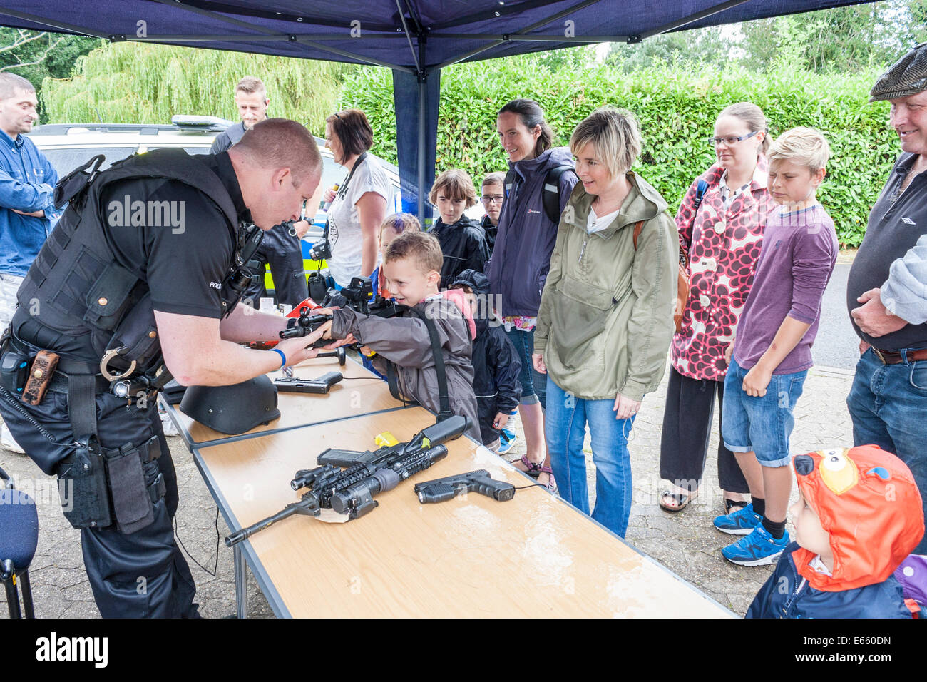 Young boy holding a Heckler & Koch MP5, demonstrated by a police ...
