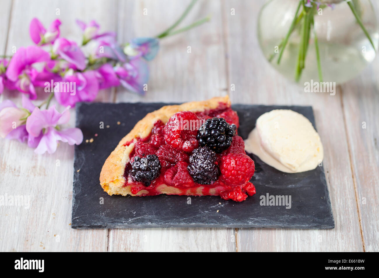 Slice of berry tart with ice cream Stock Photo - Alamy